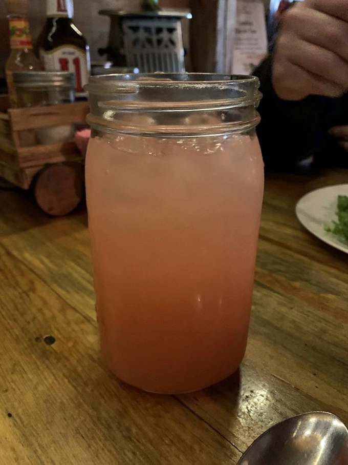Pink lemonade in a Mason jar—refreshingly tart and sweet, like liquid sunshine cutting through the savory feast ahead.