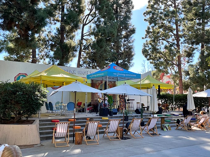 Beach chairs and umbrellas create the perfect oasis for live music enjoyment – because treasure hunting requires strategic relaxation breaks.