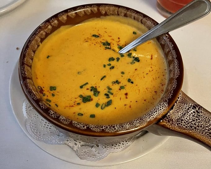 Lobster bisque so velvety smooth it could teach silk lessons. That rich orange color isn't just for show—it's a promise of flavor.