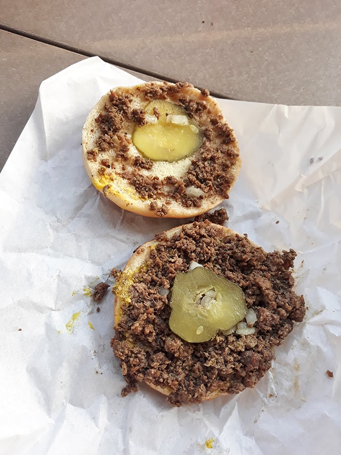 The classic Maid-Rite reveals its secrets: loose meat, pickles, and onions creating pure sandwich symphony perfection.