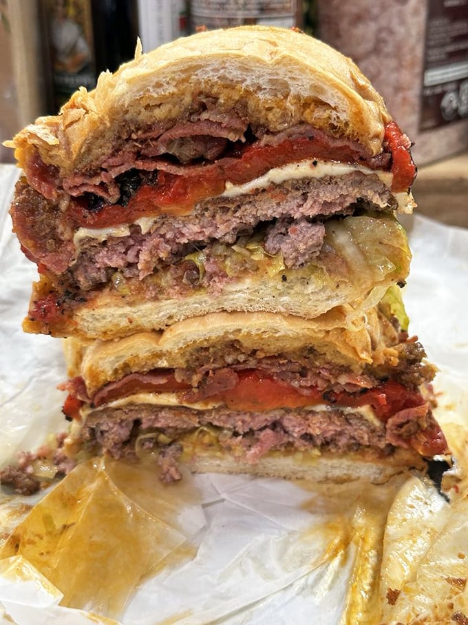 This isn't just a sandwich—it's a skyscraper of Italian meats and cheeses that requires both hands, several napkins, and possibly a nap afterward.