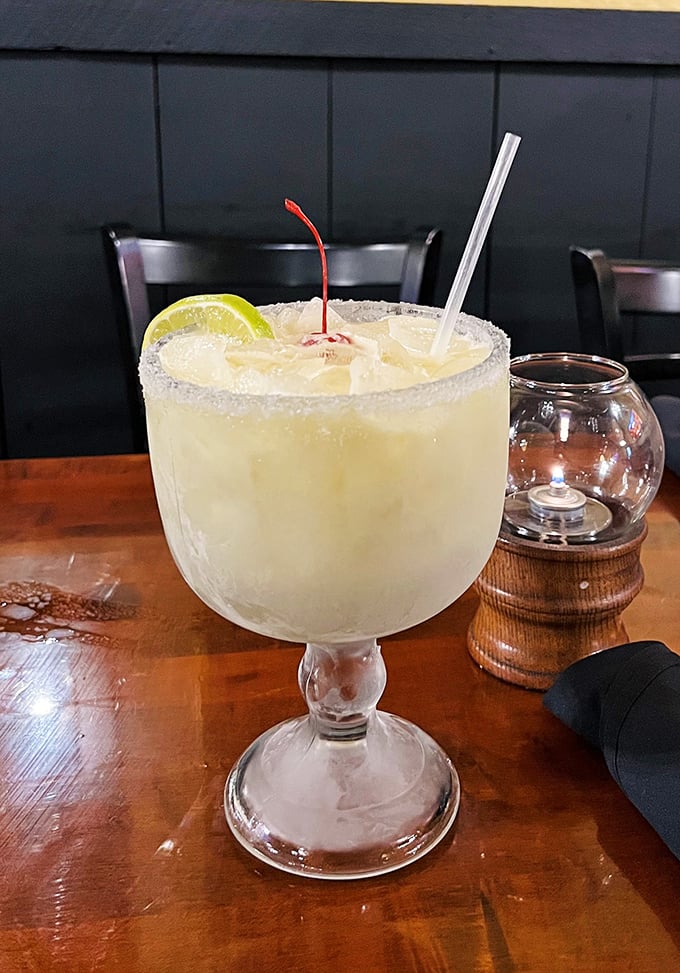 This margarita isn't messing around—served in a glass the size of a small fishbowl, it's vacation in liquid form.