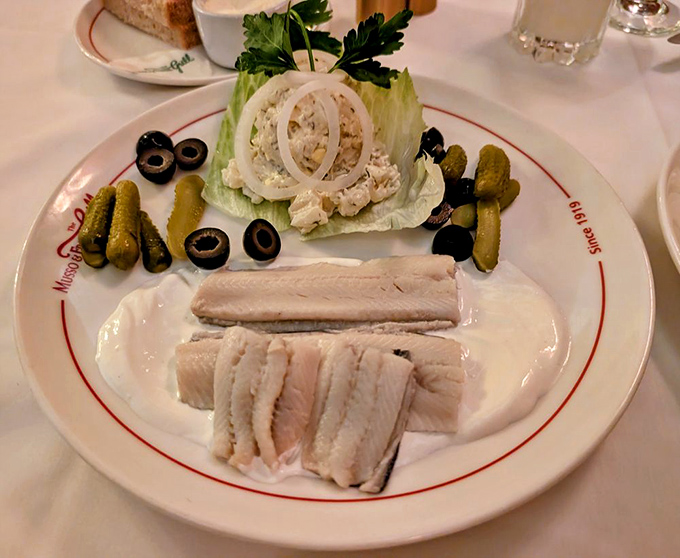 The seafood platter arrives like a supporting actor who steals the scene – pickled herring, potato salad, and garnishes arranged with old-school elegance.