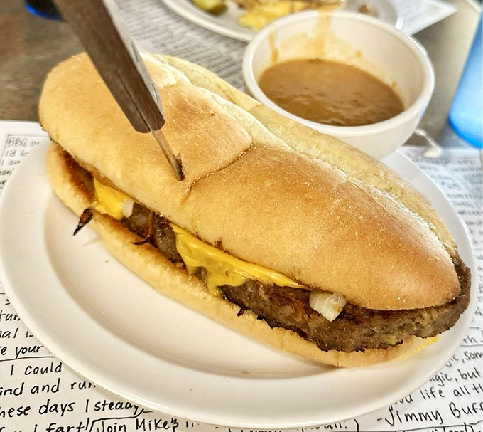 This isn't just a sandwich – it's a meat lover's dream on bread. Melted cheese cascades over the edges like a delicious waterfall.