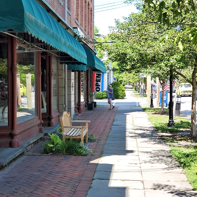 Milford's sidewalks practically narrate their own walking tour. That bench isn't just sitting there – it's waiting to offer you the best people-watching seat in town.