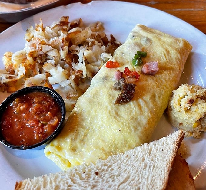 This omelet doesn't just contain ingredients—it showcases them. Paired with golden hash browns, it's breakfast harmony on a plate.