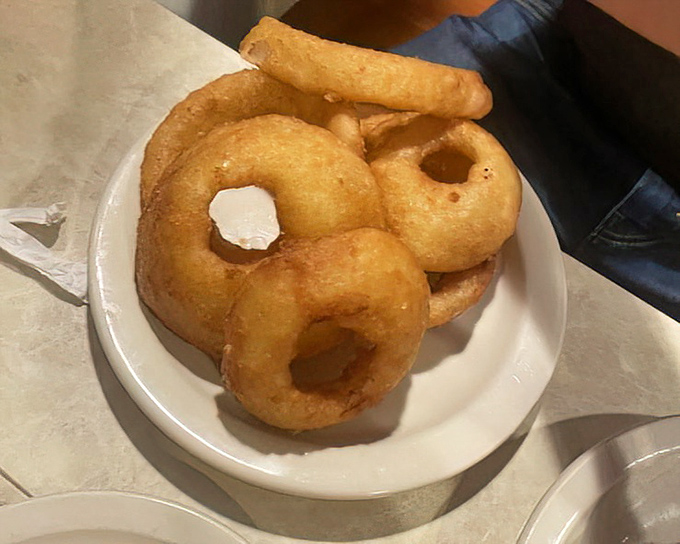 Onion rings with the perfect crunch-to-softness ratio – the kind that make you wonder why you ever waste calories on lesser versions.