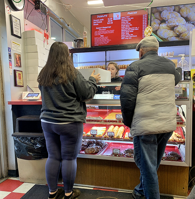 The sacred exchange of donuts for currency – a transaction as old as time and twice as satisfying.