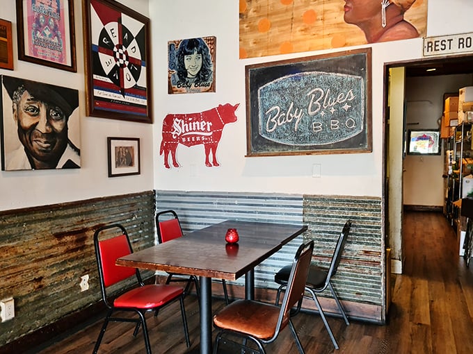 Red chairs pop against corrugated metal wainscoting—a visual reminder that this place marches to its own deliciously smoky drummer.