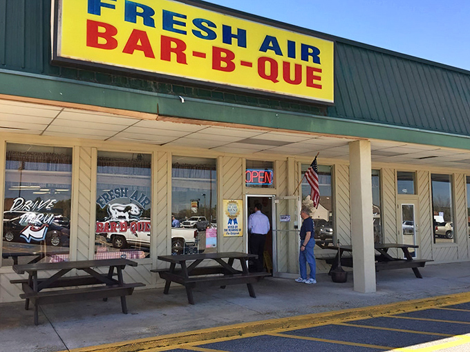 The other Fresh Air location sports a bright yellow sign—same legendary BBQ, different wrapper. Like finding your favorite band playing a second venue.