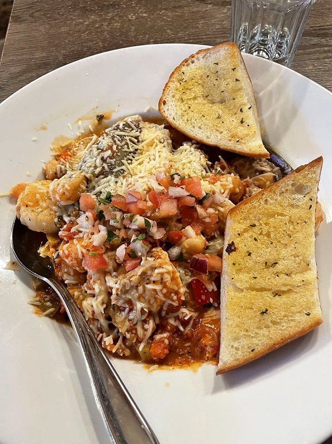 Pasta that doesn't just sit on the plate—it demands attention. Those garlic toasts aren't mere sides; they're essential sauce-sopping tools.