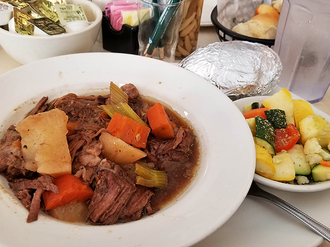 This pot roast doesn't just fall apart—it surrenders completely, surrounded by vegetables that have soaked up all that savory goodness.