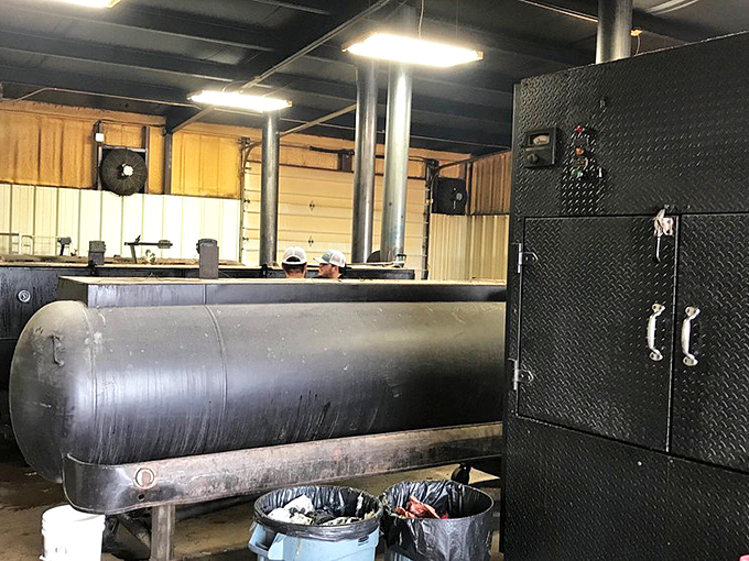 The smoker—part industrial equipment, part sacred altar—where the magic happens in a delicate dance of fire, metal, and time.