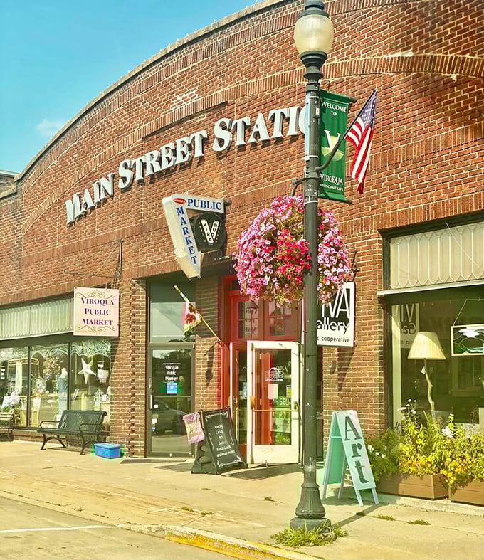 The Main Street Station's brick facade and hanging flower baskets frame the entrance to Viroqua's Public Market, where shopping becomes a social event.