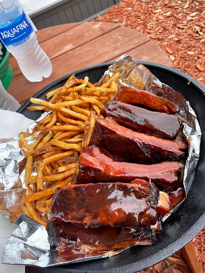 These ribs aren't just glazed—they're lacquered with a sauce so shiny you could check your reflection before diving face-first into barbecue bliss.