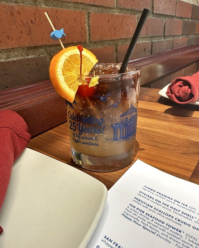 Their signature cocktail arrives with enough garnish to qualify as a small fruit salad, celebrating 25 years of making Manhattan Beach a little more spirited.
