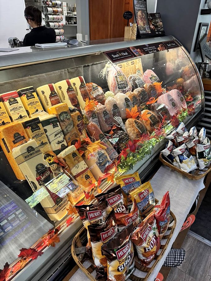 This deli case isn't just stocked—it's curated. Cheeses, meats, and seasonal decorations create a display that's practically begging to come home with you.