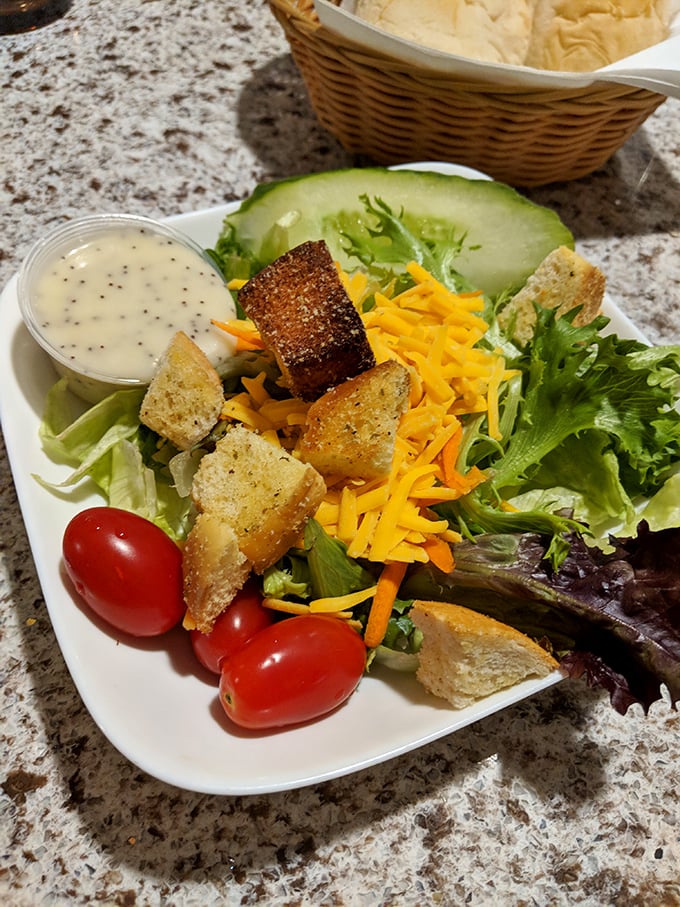 A house salad that refuses to be a boring obligation—those homemade croutons have purpose and conviction.