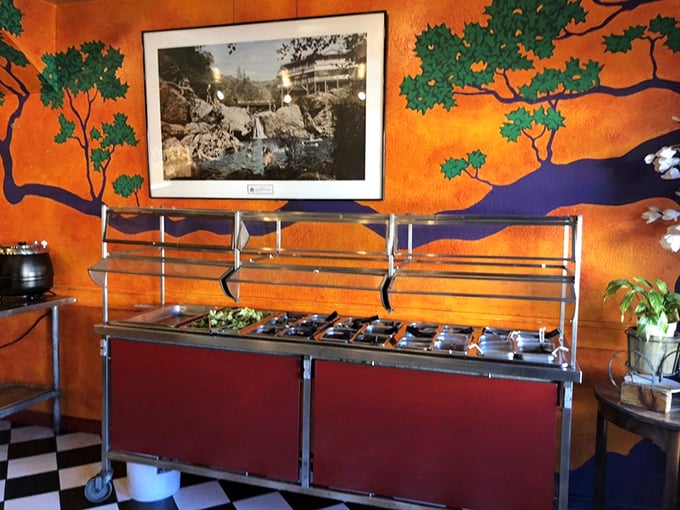 The salad bar's vibrant colors pop against the orange mural backdrop—proof that even a historic saloon understands the importance of fresh options.