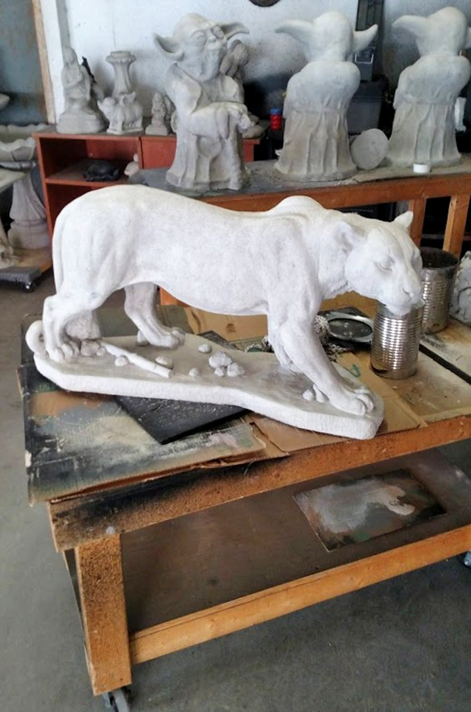Unpainted possibilities waiting for their colorful futures. That stoic panther has the quiet dignity of someone who knows they'll eventually be the centerpiece of someone's garden.