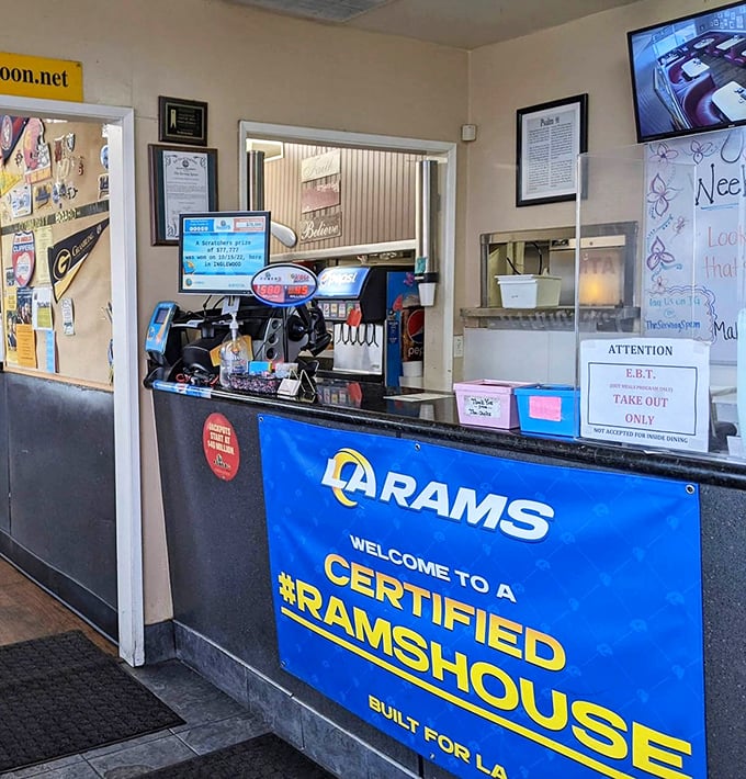 The service counter displays local pride with Rams memorabilia, proving sports and good food go together.