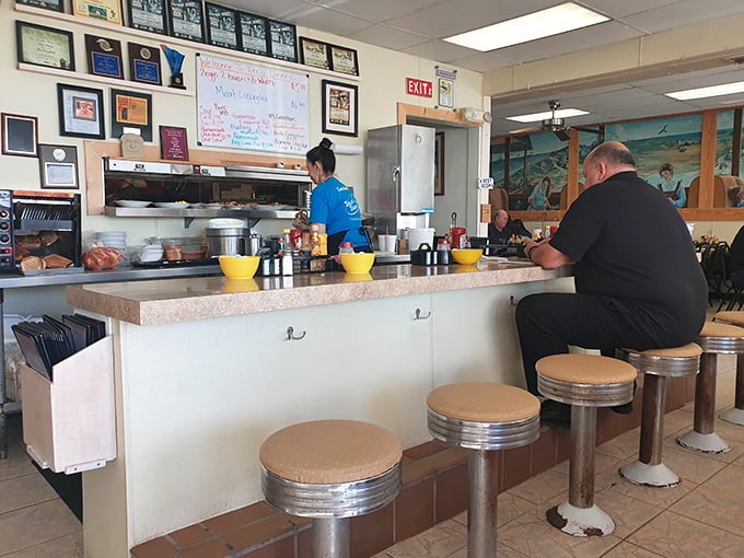 Where breakfast decisions are made and coffee refills appear like magic. The worn counter tells stories of thousands of satisfied appetites.