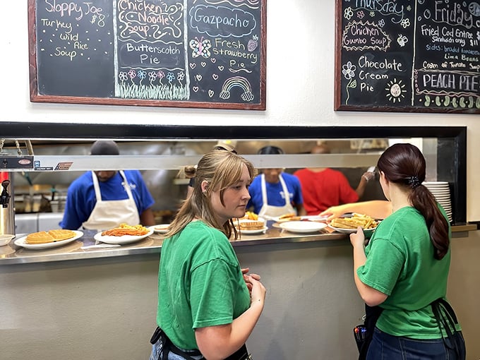 Behind the scenes where breakfast dreams become reality – the pass-through window frames a glimpse into the choreographed chaos of short-order cooking.