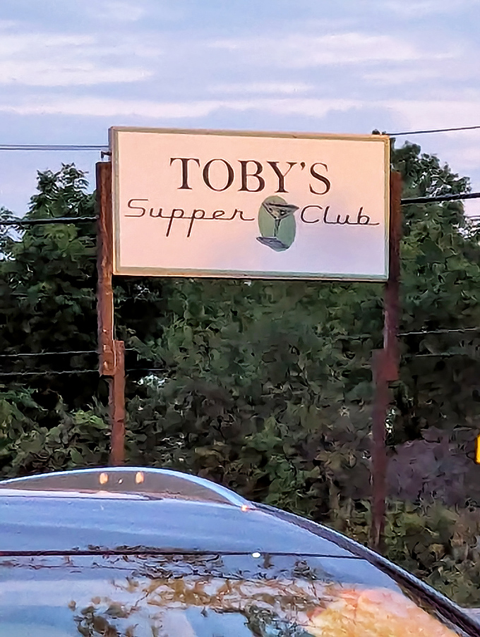 The roadside sign beckons like an old friend, promising comfort and satisfaction in equal measure – Wisconsin's version of a North Star.