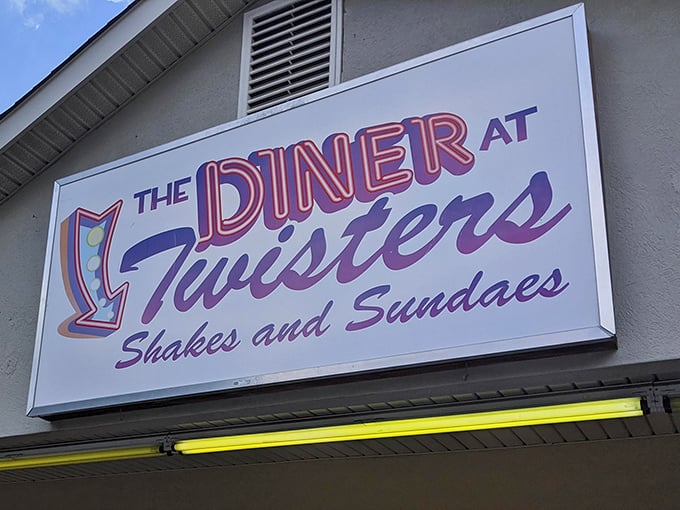 That retro sign with its swooping arrow practically beckons you in from the road, promising sweet relief from whatever ails you.