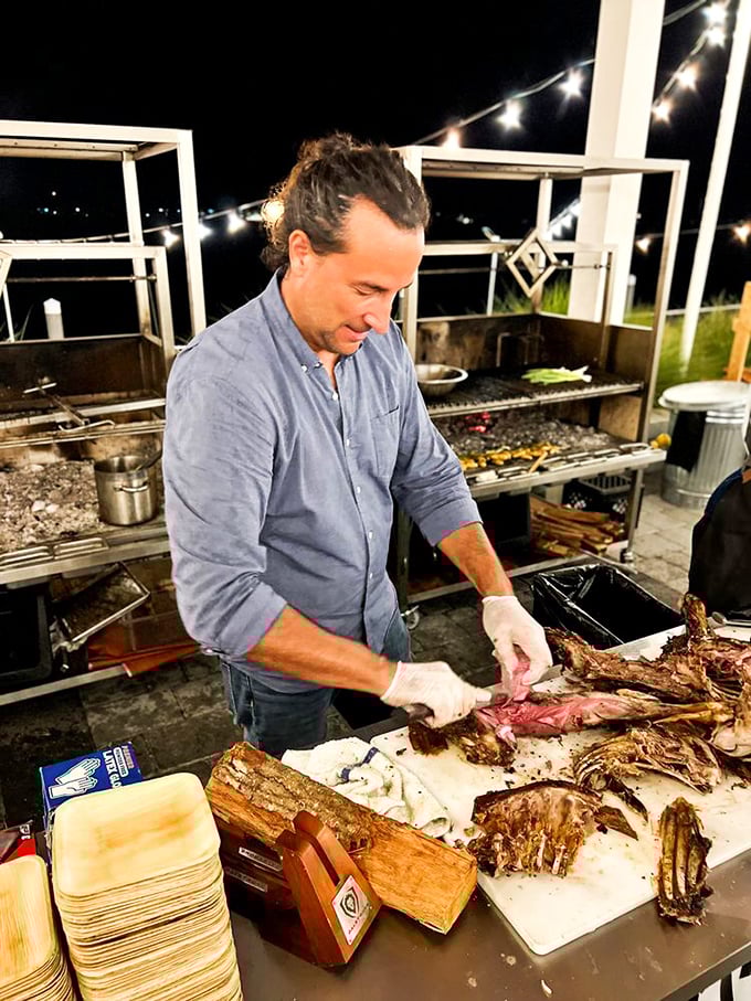 Master grillers working their magic outdoors, where real Argentine barbecue happens under the open sky and twinkling lights.