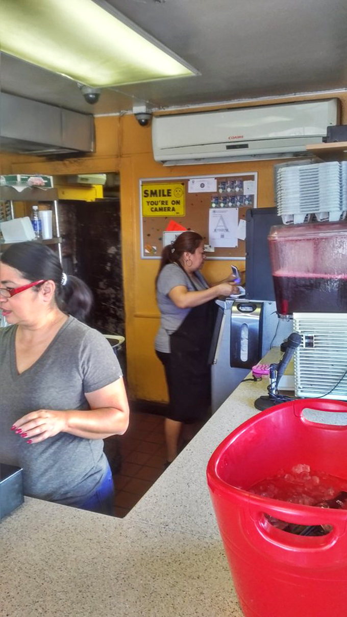 Where the magic happens. The busy kitchen staff moves with the practiced efficiency of people who know these recipes by heart.