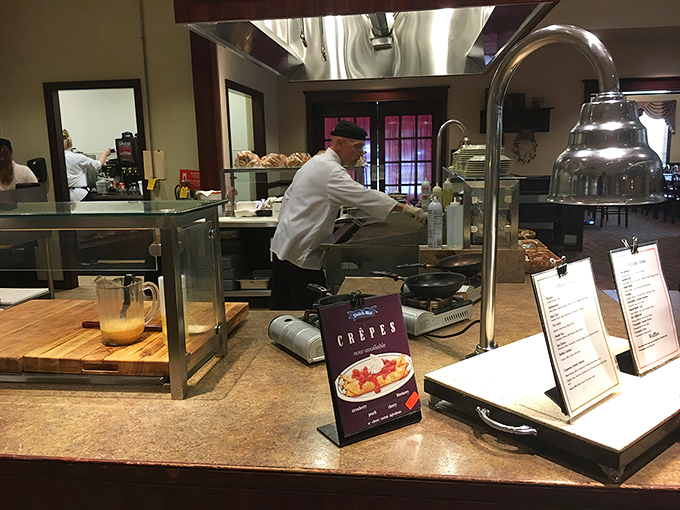 Behind every great meal is a dedicated team—this chef focuses intently on preparing crepes that will soon make someone's day a little brighter.