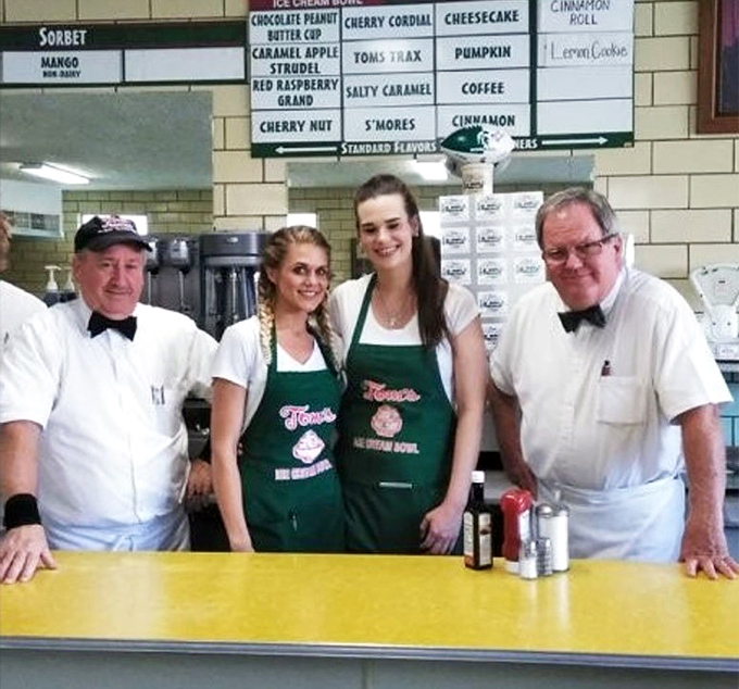 The team behind the counter wears their bow ties with pride. These aren't just servers—they're ambassadors of frozen happiness.