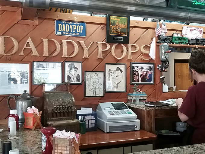 The wall of memories behind the register reminds you that you're not just eating breakfast—you're becoming part of Daddypops history.