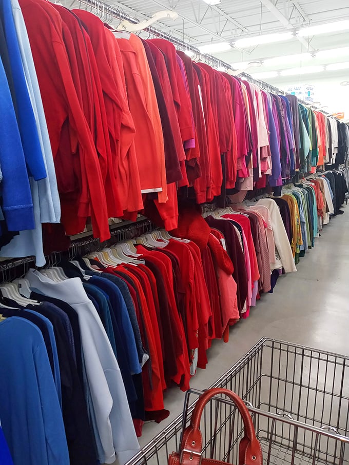 The rainbow wall of sweaters and shirts, organized by color, makes finding your perfect shade of red easier than explaining why you need another one.