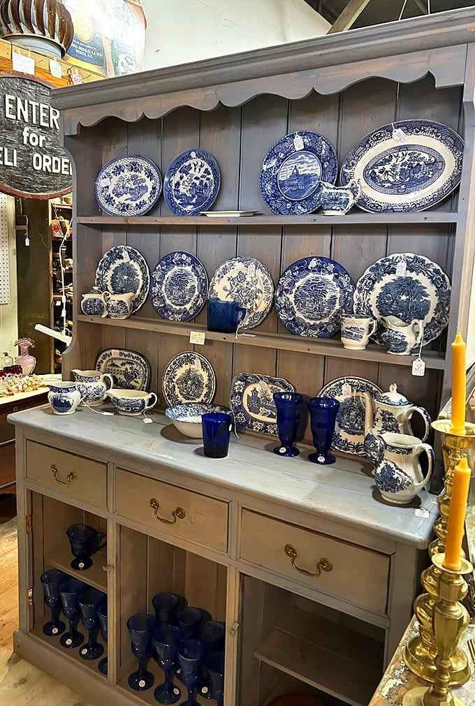 Blue Willow china displayed like a Delft museum exploded in the best possible way – your aunt would approve.