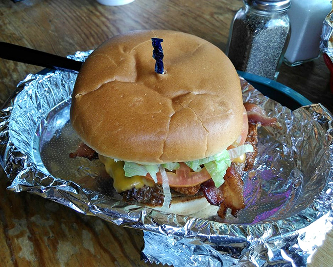 A burger so tall it needs a toothpick support beam. Architecture and gastronomy coming together in perfect harmony.