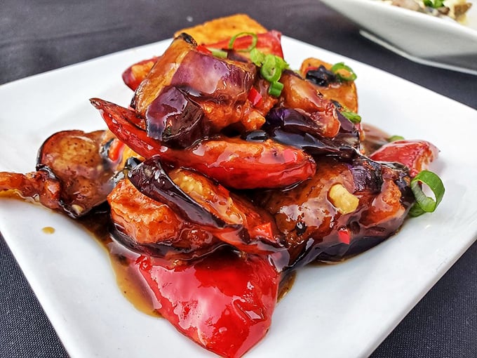 Eggplant and peppers glistening in sauce like they've just emerged from a spa treatment. Vegetables have never looked so ready for their close-up.