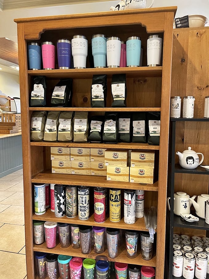 A wooden shelf of travel mugs and coffee beans stands ready to ensure your caffeine addiction doesn't end when you leave the premises.