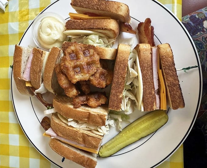 A triple-decker club that requires jaw exercises beforehand—layers of satisfaction held together by the toothpicks of tradition.
