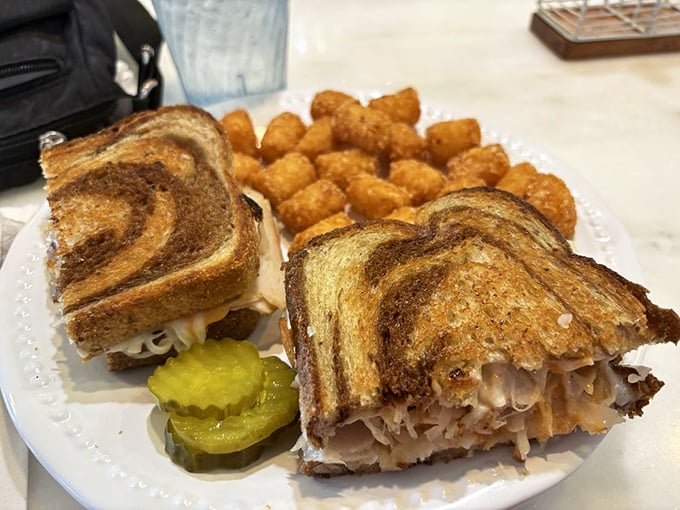 This turkey Reuben with golden tots isn't just lunch – it's proof that The Blue Berry Café excels beyond breakfast hours.