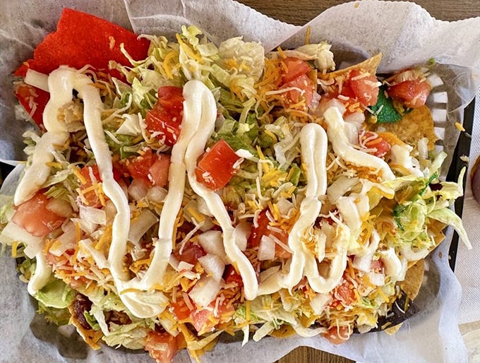 These ultimate nachos don't understand the concept of empty space—every chip is a foundation for a tower of toppings and that zigzag of sauce.