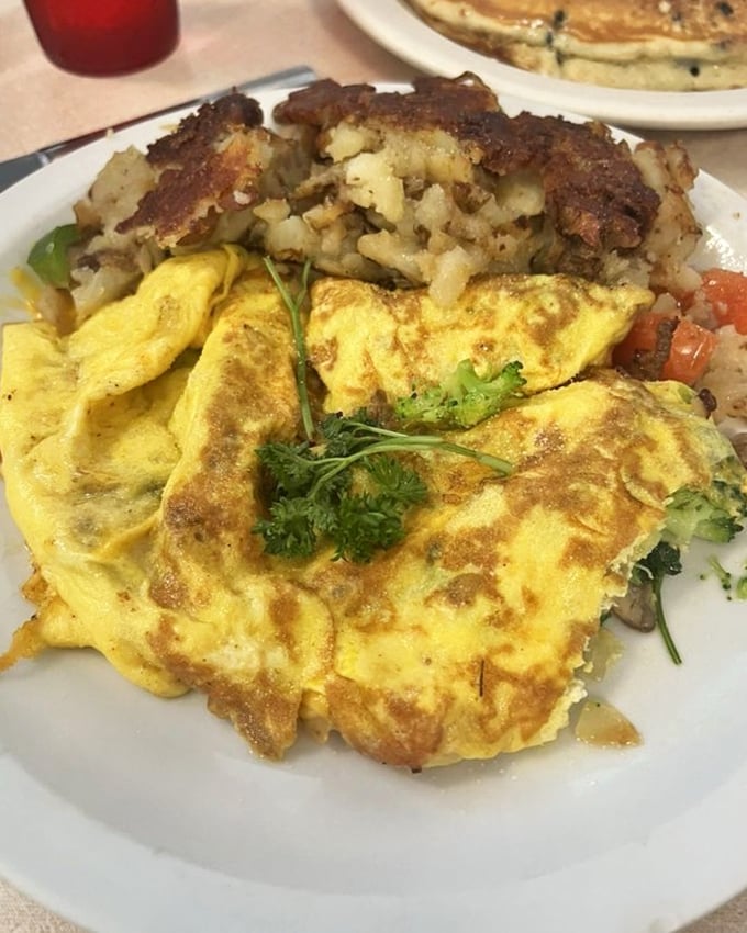 An omelet that's achieved the perfect balance between fluffy and substantial, with a side of crispy potatoes that deserve their own fan club.