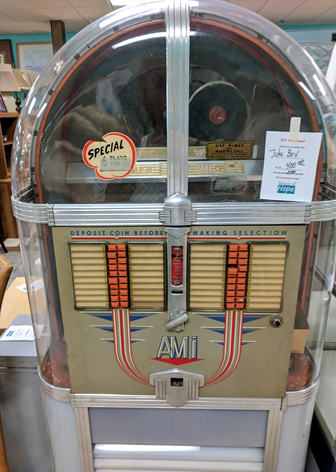 This vintage jukebox isn't just furniture—it's a time machine that accepts quarters instead of plutonium. Probably played "Margaritaville" more times than Jimmy Buffett himself.