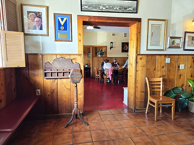The waiting area's wooden details and vintage menu stand whisper, "Good things come to those who wait… especially our artichoke soup."