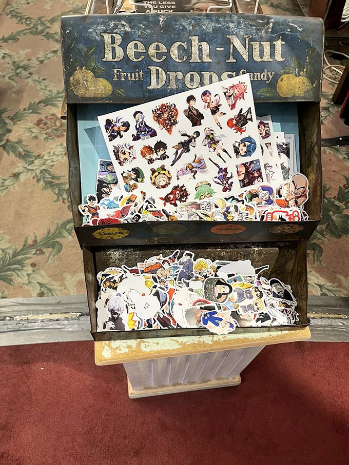 An old Beech-Nut display finds new purpose housing anime stickers – proof that vintage containers and modern fandoms make surprisingly perfect roommates.
