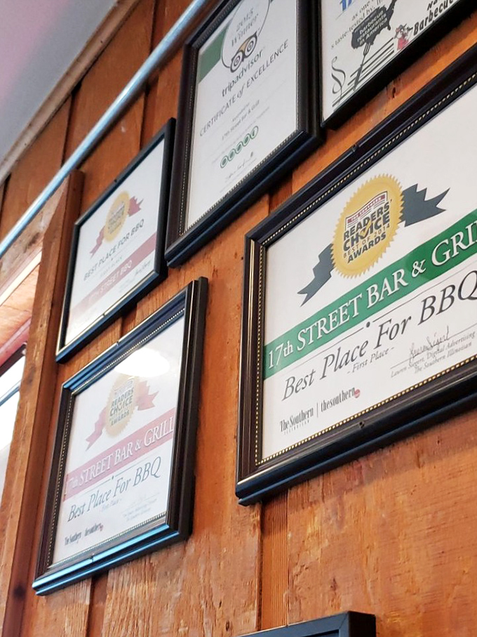 The wall of fame doesn't lie – these aren't participation trophies, they're battle scars from barbecue competitions conquered.