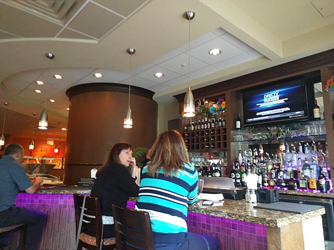 The bar area—where strangers become friends and friends become regulars over perfectly mixed drinks and shared appetizers.