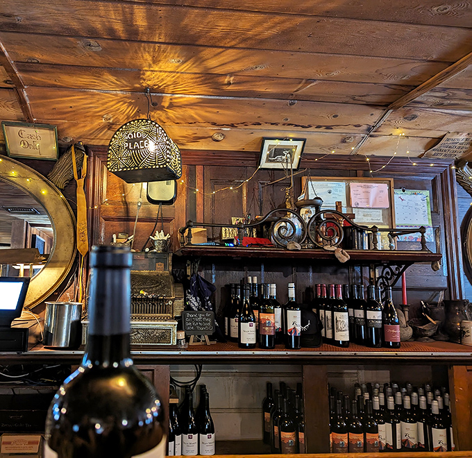 The bar area feels like a saloon from another era. Those bottles aren't just drinks—they're liquid companions to the stories you'll share around the wooden tables.