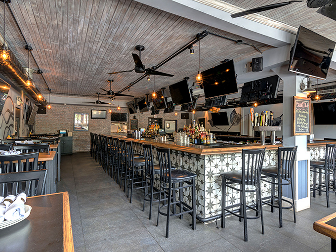 The bar area beckons with geometric flair, proving that great seafood houses can be both stylish and approachable.
